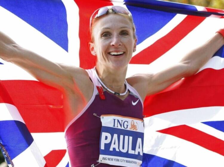 Paula Radcliffe of England holds the Union Jack after winning the Women ...